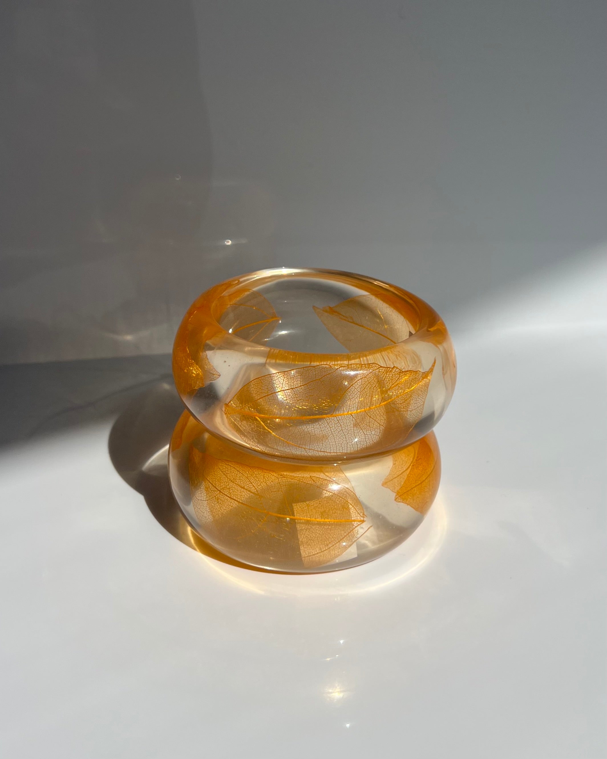 CLEAR CHUNKY BANGLES WITH FLOWERS INSIDE – SOIGNEE BY SHANA COLE